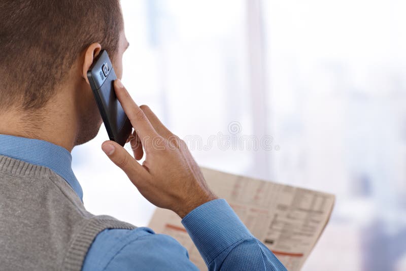 Man with Phone and Newspaper Stock Image - Image of house, newspaper ...