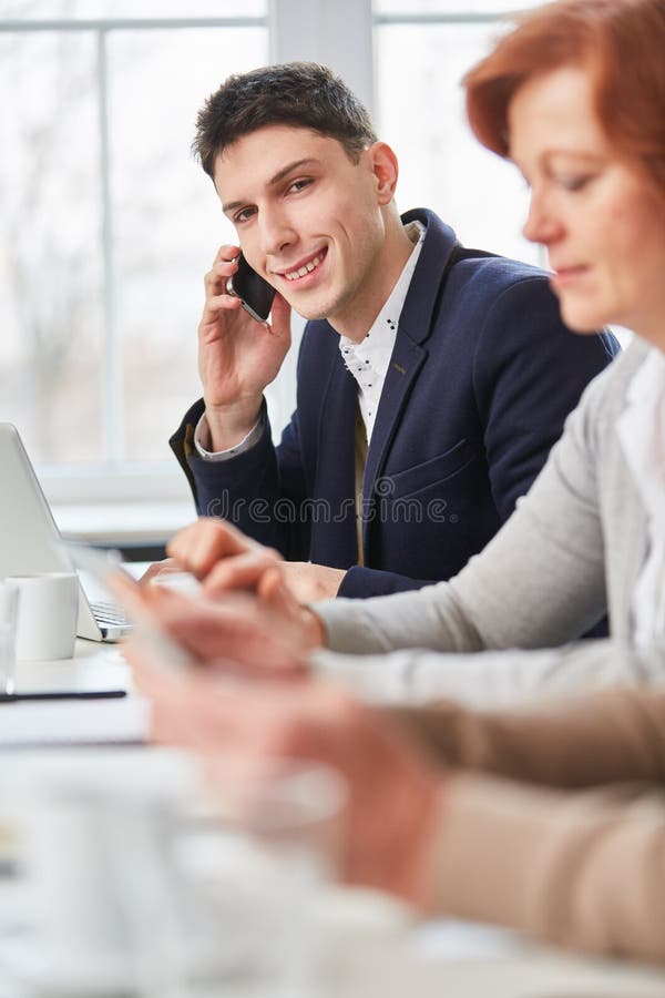 Businessman on the Phone with Smartphone in Meeting Stock Photo - Image ...