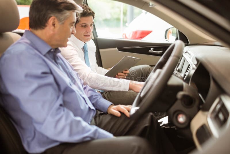 Businessman Pointing a Car Interior Stock Image - Image of showroom ...