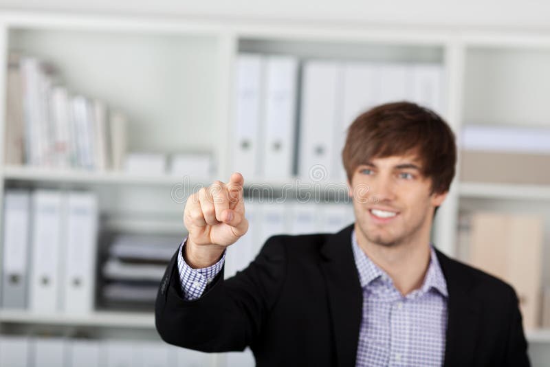 Businessman Pointing at Invisible Screen in Office Stock Image - Image ...
