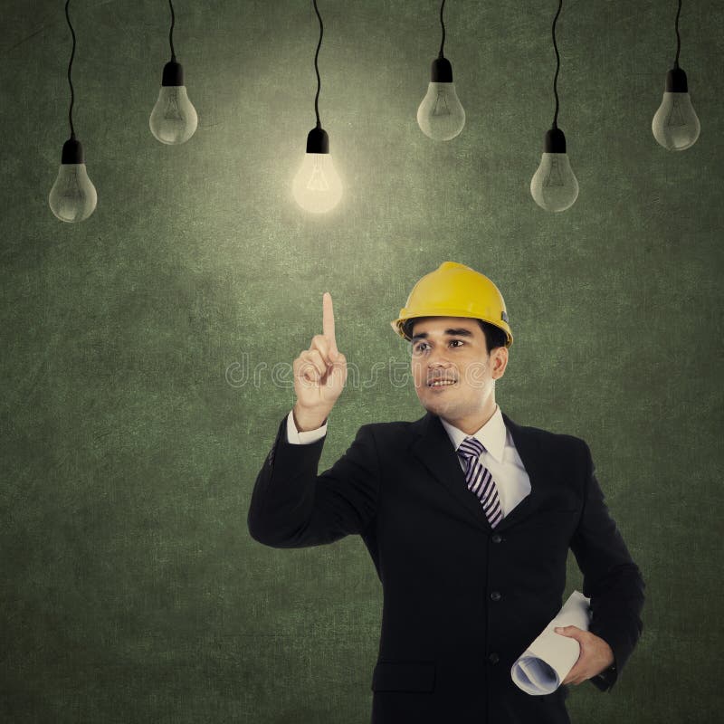 Businessman Pointing at Light Bulb Stock Image - Image of lamp ...