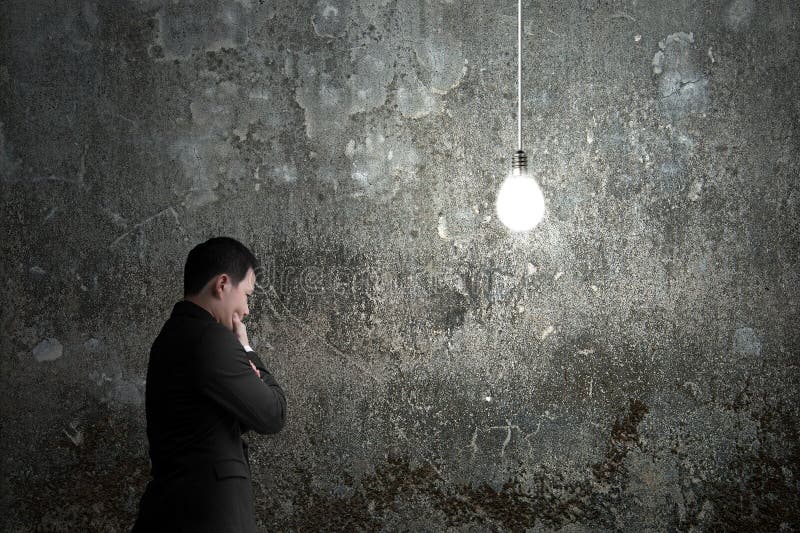 Businessman Pondering with Brightly Light Bulb Illuminated Dark Stock ...