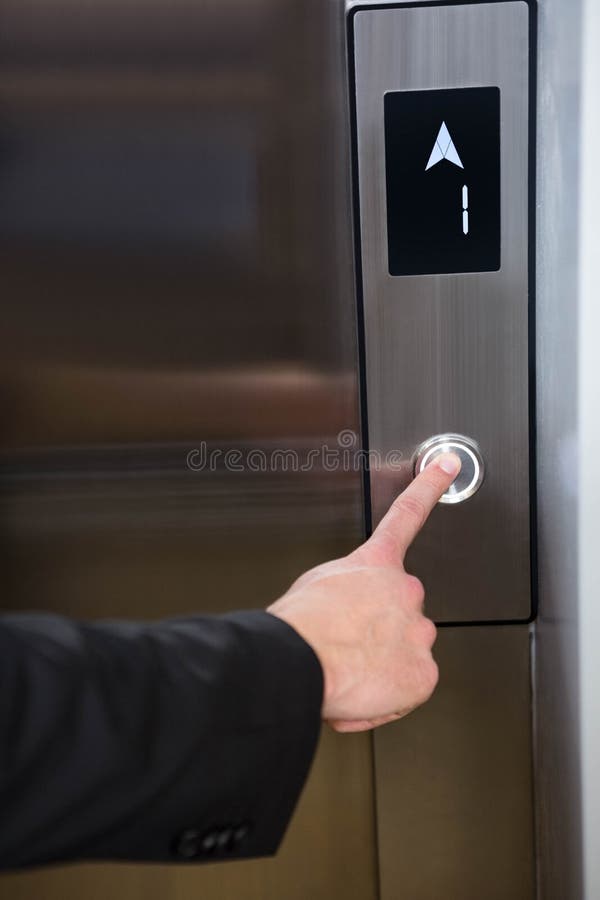 Businessman Pressing The Button In The Elevator Stock Image - Image of ...