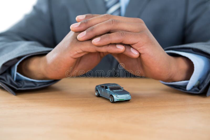 Businessman Protecting Toy Car with Hands Stock Image - Image of desk ...