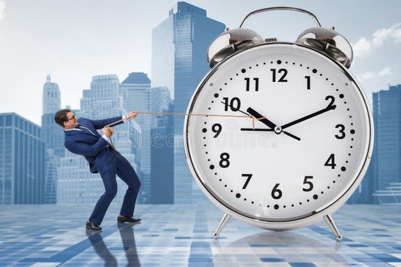 The Businessman Pulling Clock in Time Management Concept Stock Photo ...