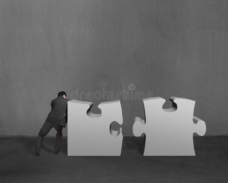 Businessman Push Two Heavy Puzzles Together in Concrete Wall Background ...