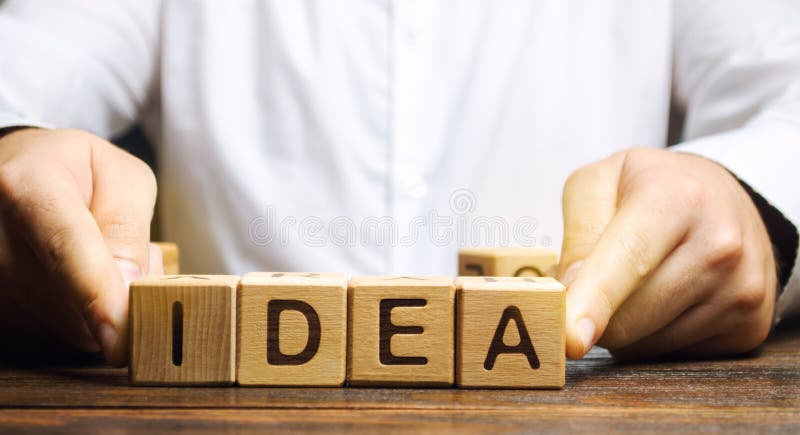 Businessman Puts Wooden Blocks with the Word Idea. Generation of ...