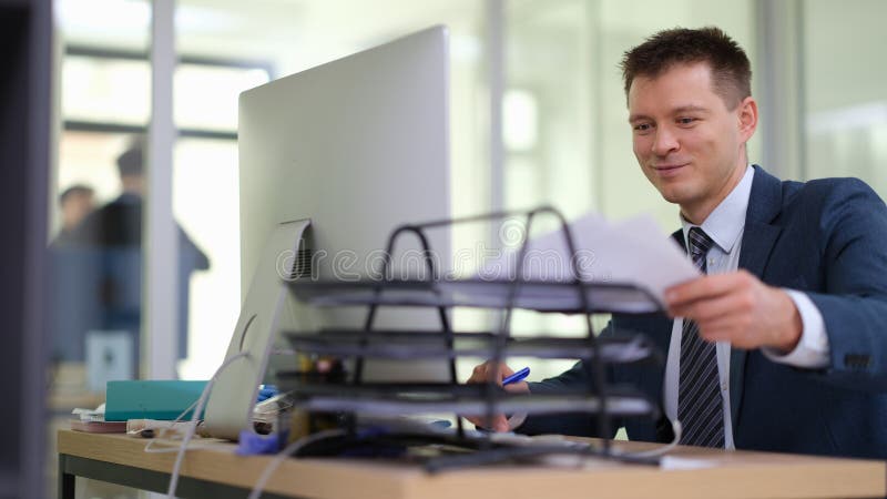Businessman Putting Paper Documents on Stand on Table in Office Stock ...