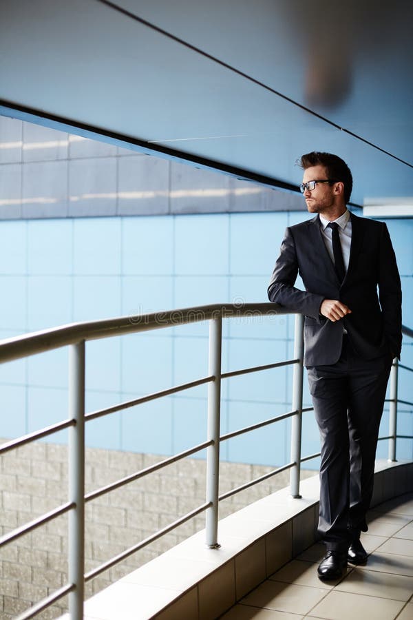 Businessman by railings stock photo. Image of confident - 54829666