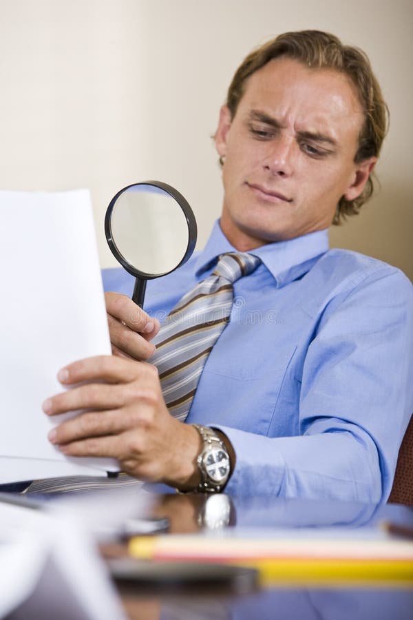 Businessman Reading Fine Print in Contract Stock Image - Image of ...