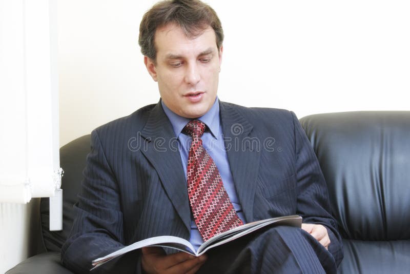 Businessman Reading Magazine Stock Photo - Image of office, black: 12715230