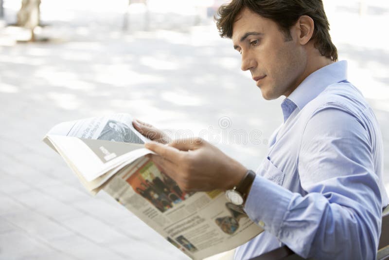 Businessman Reading Newspaper on Bench Stock Image - Image of ...