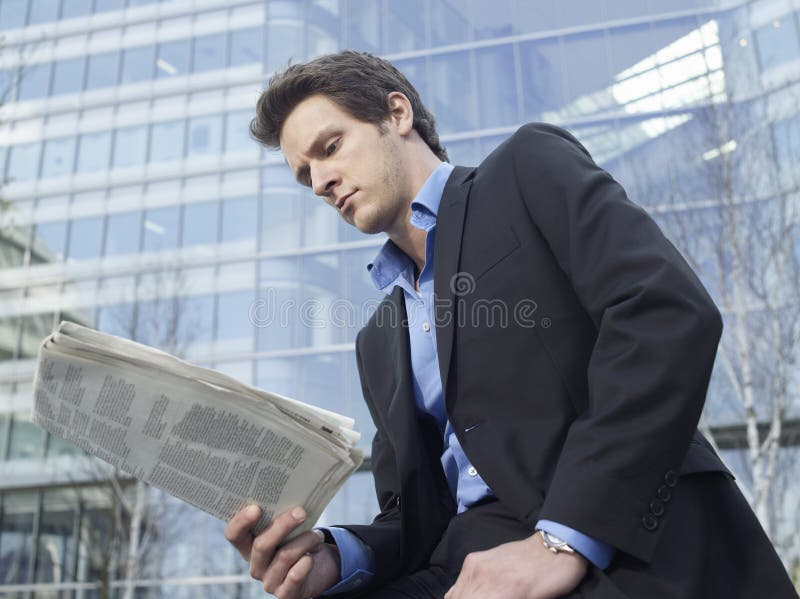 Businessman Reading Newspaper Stock Image - Image of reading, outdoors ...