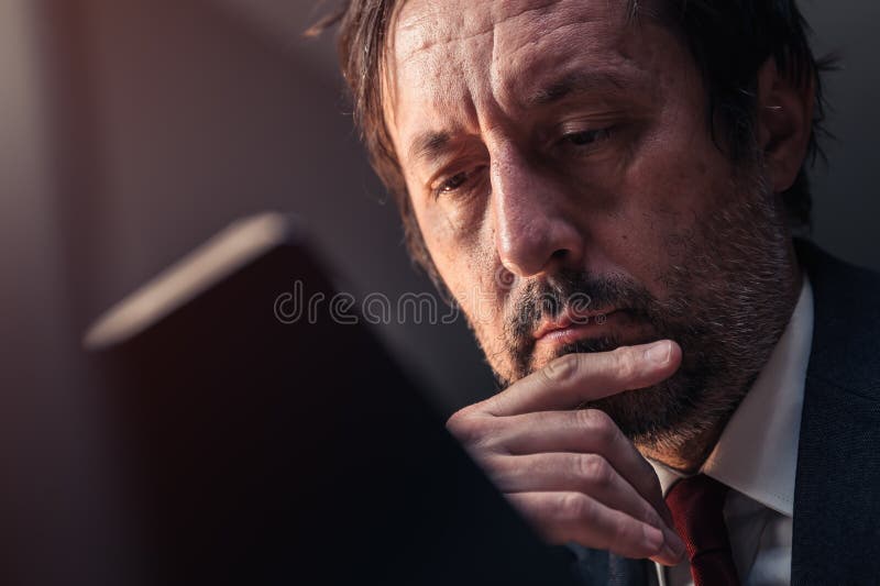 Businessman Reading Notes from Black Notebook in Office Late at Night ...