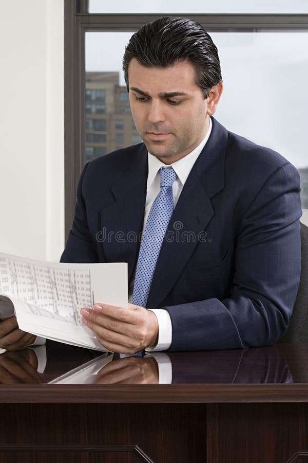 Businessman reading report stock photo. Image of file - 62560942