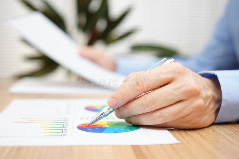Businessman is Reading Report and Checking Data on Graph Stock Image ...