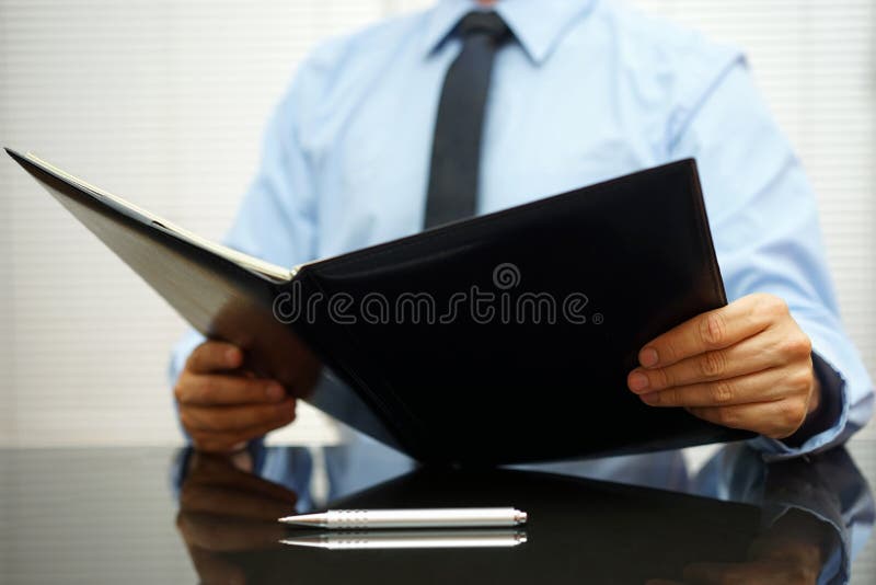 Businessman is Reading Report from Notebook Stock Image - Image of ...