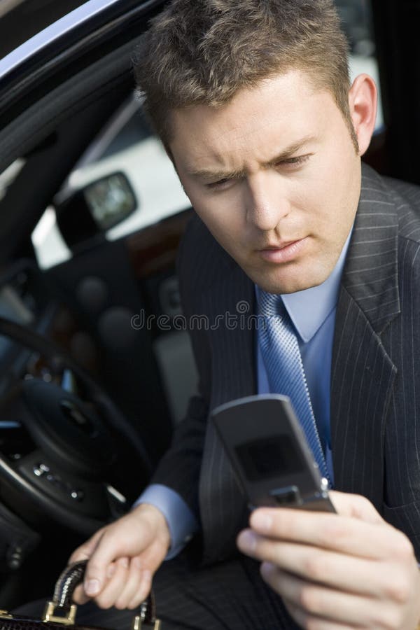 Businessman Reading Text Message on His Cell Phone Stock Photo - Image ...
