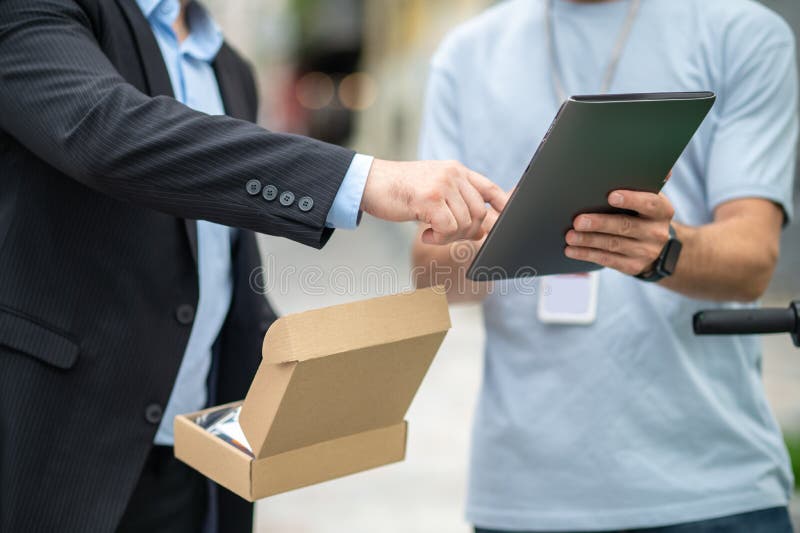 Businessman Receiving a Delivery Box from the Courrier on a Scooter ...