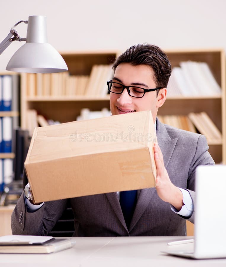 Businessman Receiving Parcel in Office Stock Photo - Image of packaging ...