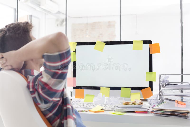 Businessman Relaxing in Front of Computer with Blank Screen in Office ...