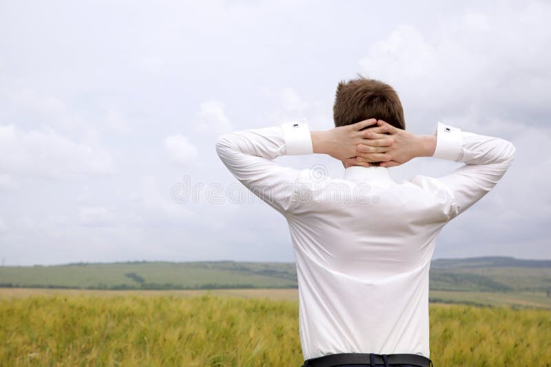 Businessman is Resting in the Field Thinking of about the Future Stock ...