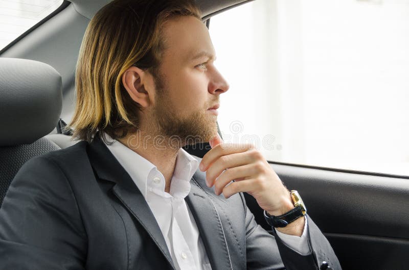 Businessman riding in car stock photo. Image of people - 76672004