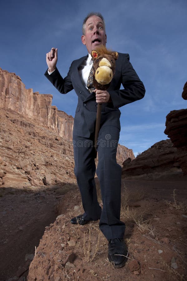 Businessman Riding a Stick Horse Stock Image - Image of happy, outdoors ...