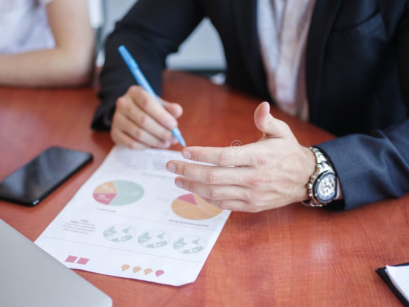 Hands of Businessmen on a Table Behind Papers Stock Photo - Image of ...