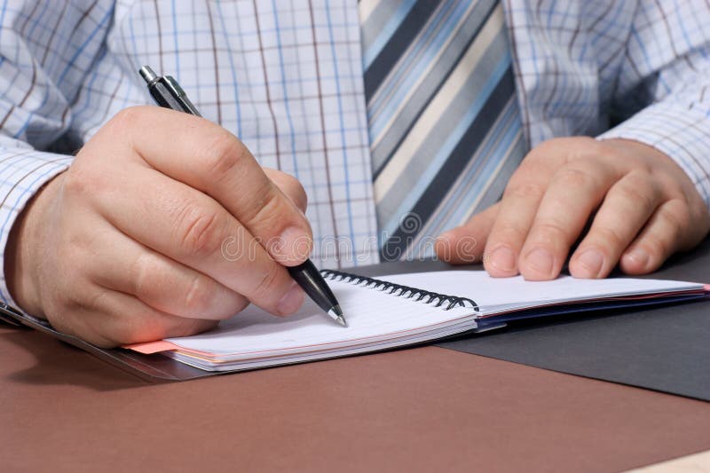 Businessman S Hand with a Pen Writing Something. Stock Image - Image of ...