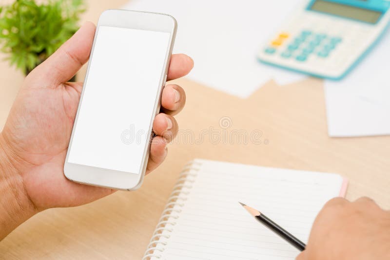 Businessman`s Hands Holding and Use Mobile Phone on on Office Table ...