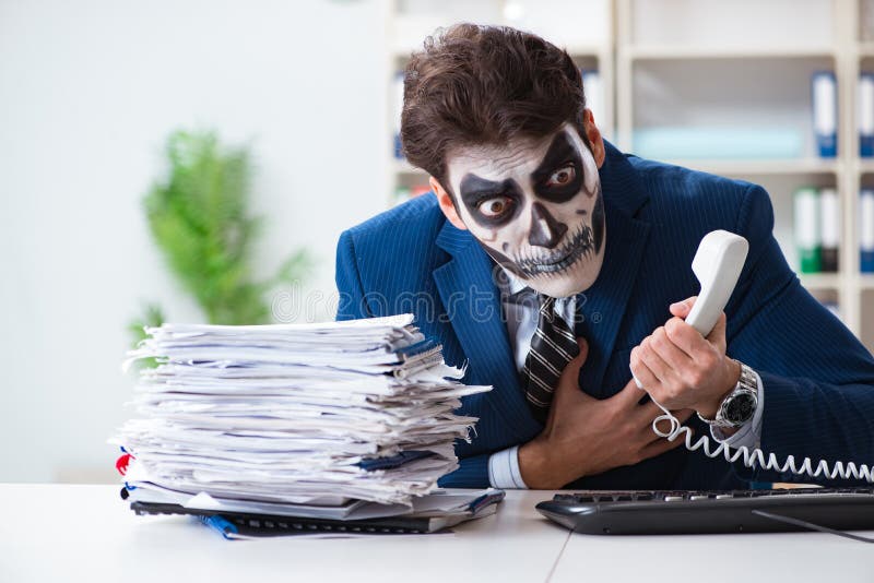 Businessman with Scary Face Mask Working in Office Stock Photo - Image ...