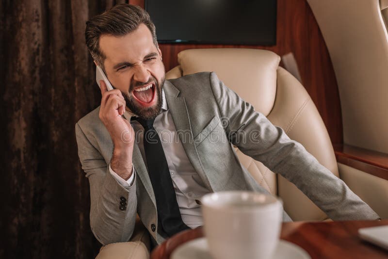 Businessman Screaming on Smartphone while Flying in Private Jet Stock ...