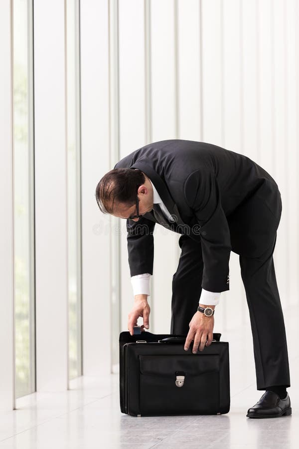 Businessman Searching for Something in Briefcase Stock Image - Image of ...