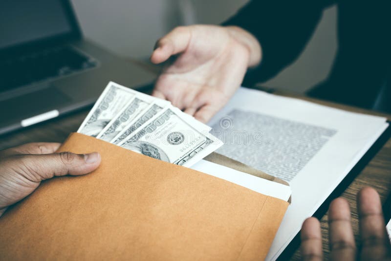 Businessman Secretly Giving a Bribe by Giving Money Bills in Envelope ...