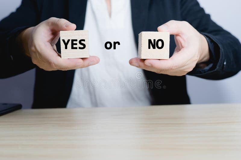 Businessman is Selecting a Block that Has the Word Yes or No on it ...