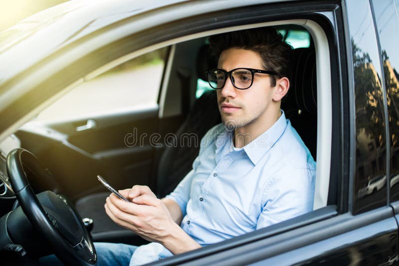 Handsome Businessman Sending a Text Message in His Car Stock Image ...