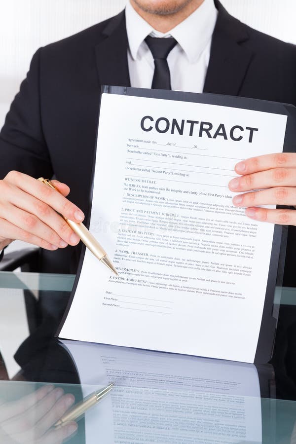 Businessman Showing Contract Paper at Office Desk Stock Photo - Image ...