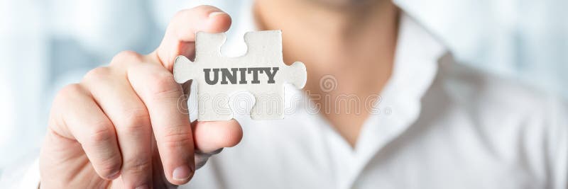 Businessman Showing Puzzle Piece with Unity Text Stock Image - Image of ...