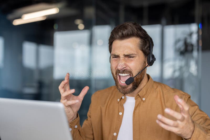 Frustrated Businessman in Headset Expressing Anger while Working in ...