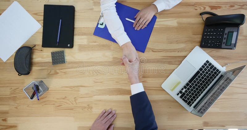Businessman Signing a Contract with Desktop and Paperwork on Background ...