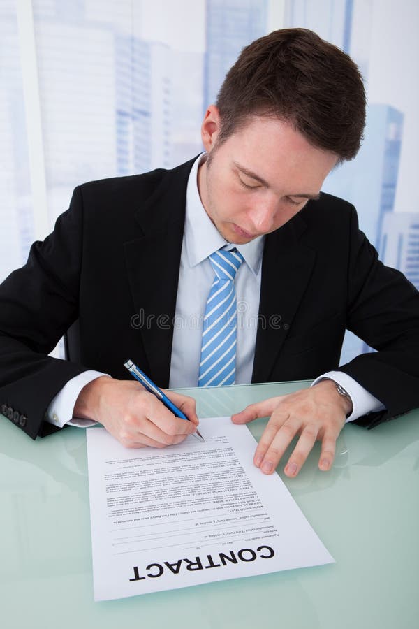 Businessman Signing Contract Paper at Desk Stock Photo - Image of ...