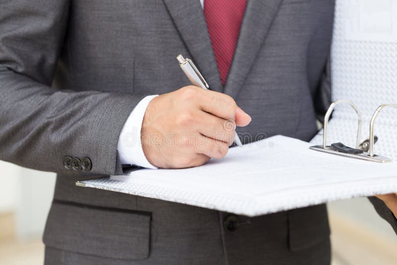 Businessman Signing a Document Stock Image - Image of paperwork ...