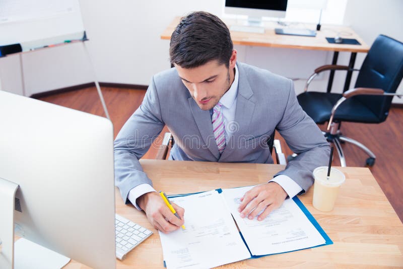 Businessman Signing Document in Office Stock Photo - Image of ...
