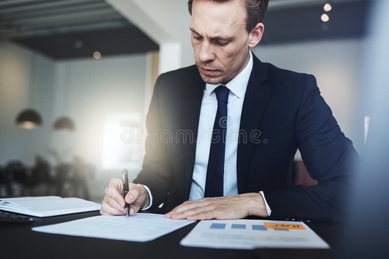 Businessman Signing Documents while Sitting at His Office Desk Stock ...