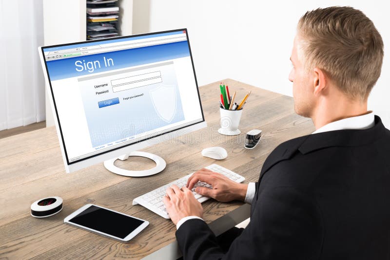 Businessman Signing into a Website on Computer Stock Photo - Image of ...