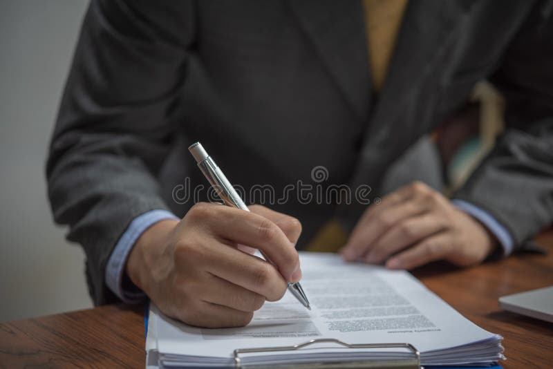 Businessman Signs Documents with a Pen Making the Signature on Desk ...