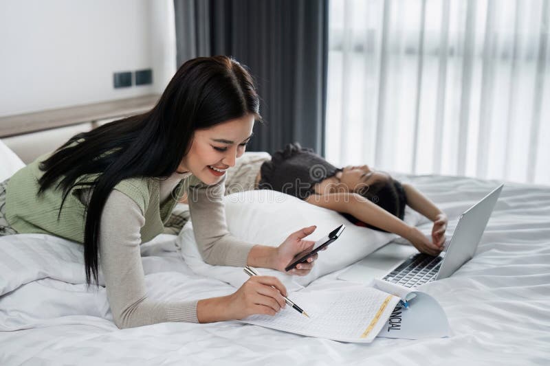 Businessman Sit on Bed Doing Document Brought Home from Work while ...