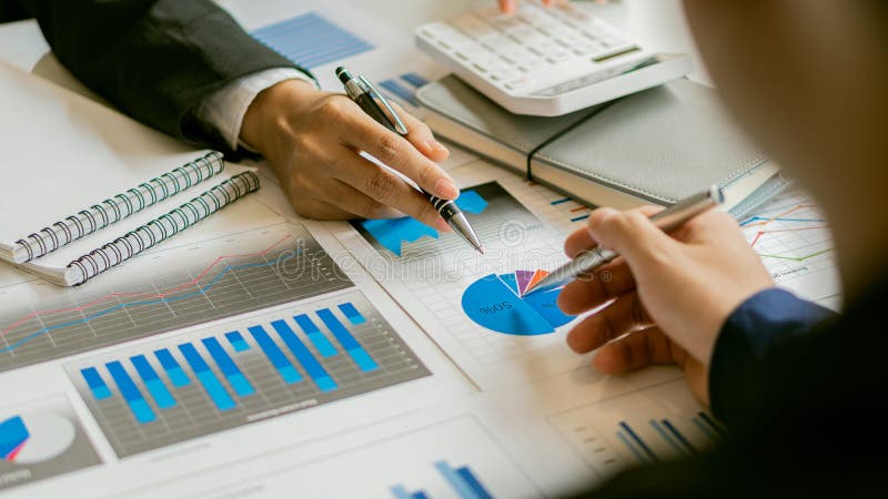 A Businessman Sits at the Graph Analysis Desk. on Graphics and Charts ...