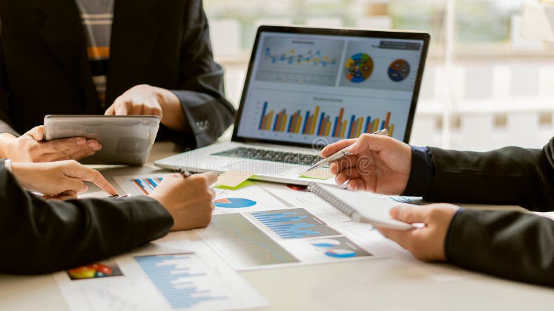 A Businessman Sits at the Graph Analysis Desk. on Graphics and Charts ...